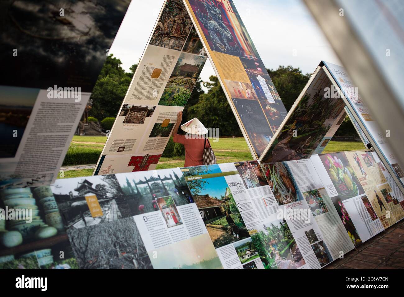 Woman stands amidst informational display at Hue Citadel Stock Photo ...