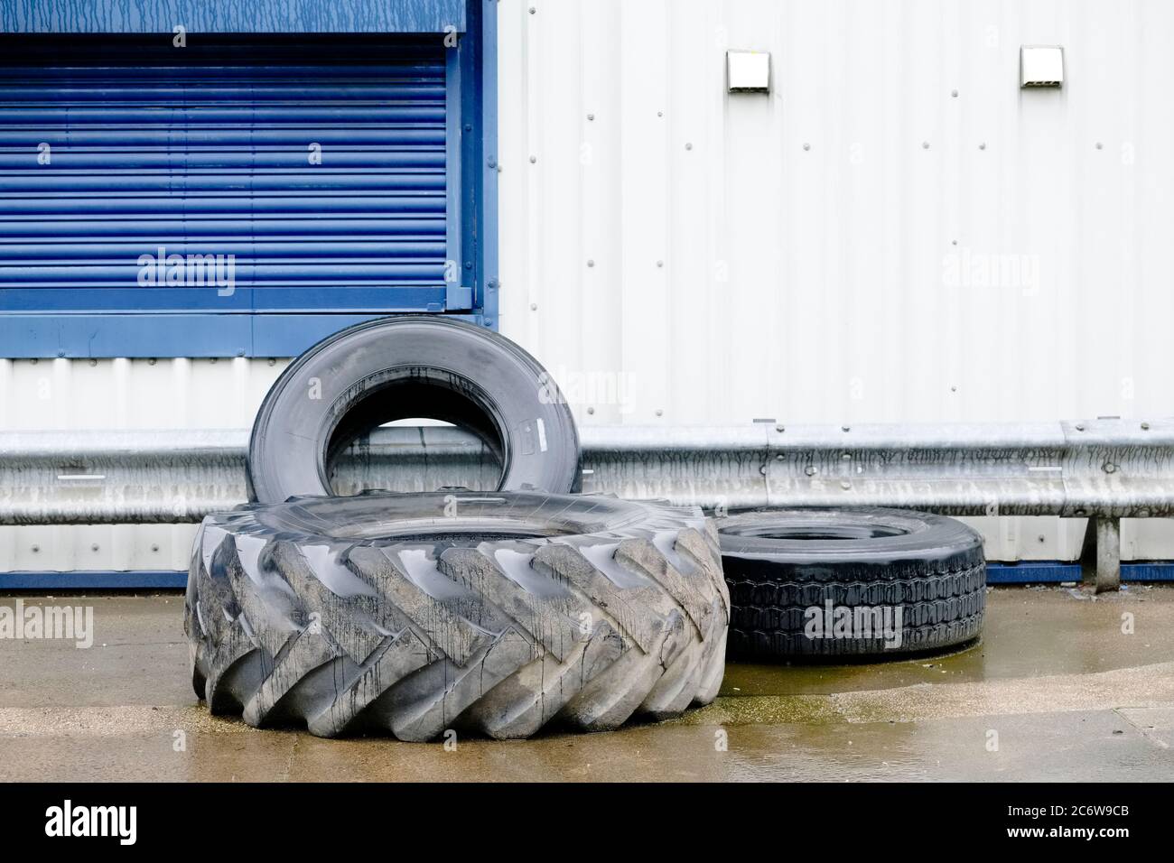 Car tyres stacked recycling compound environment old used rubber black ...