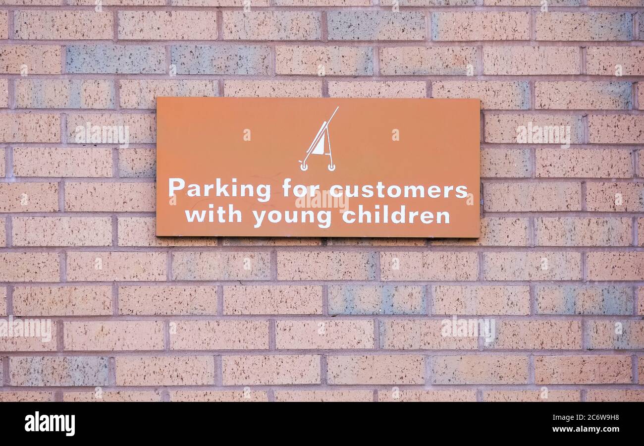 Parent and child parking only sign on large open white wall space in ...