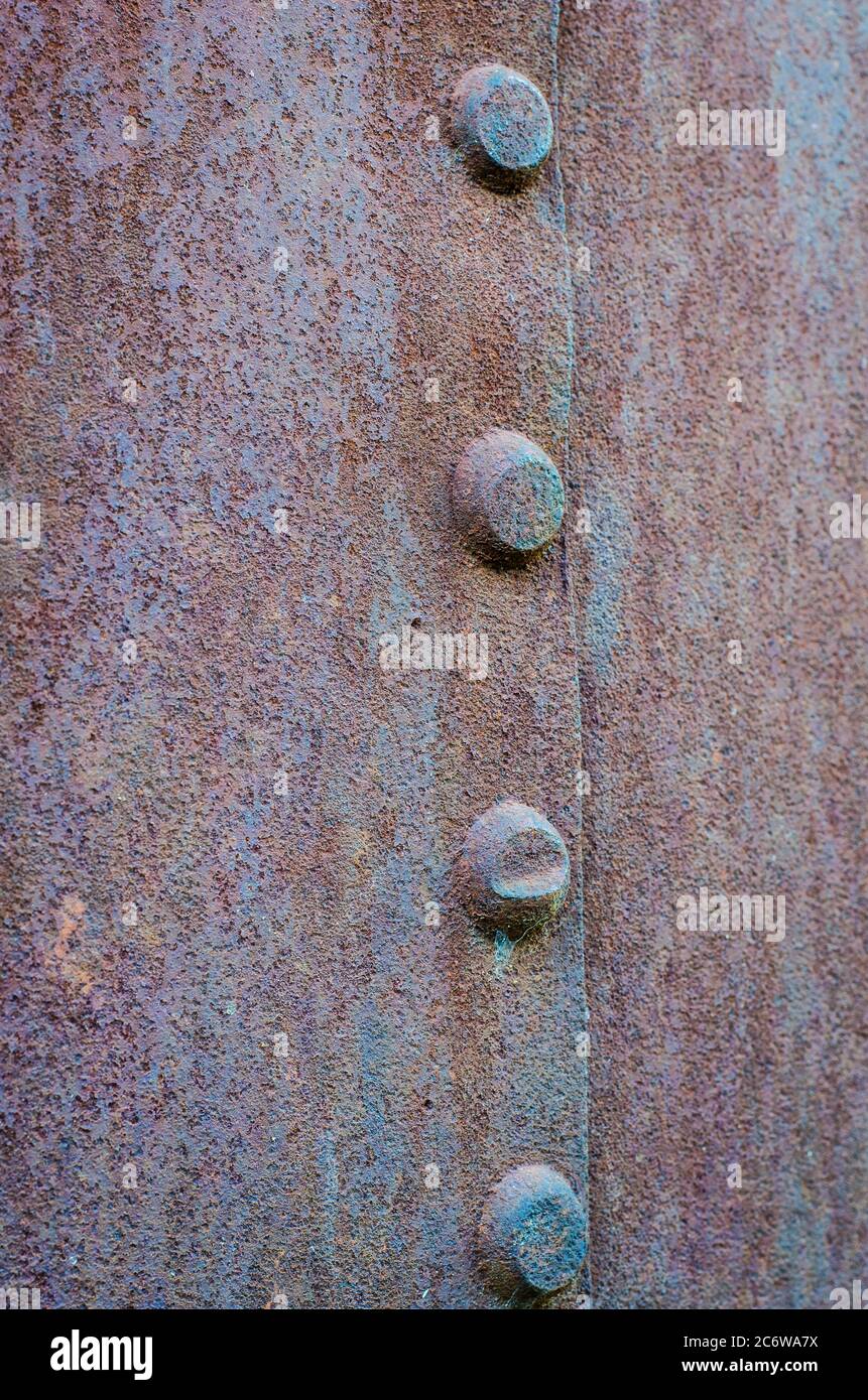 Fragment Rusty riveted hull of an old ship. Large metal rivets metal ...