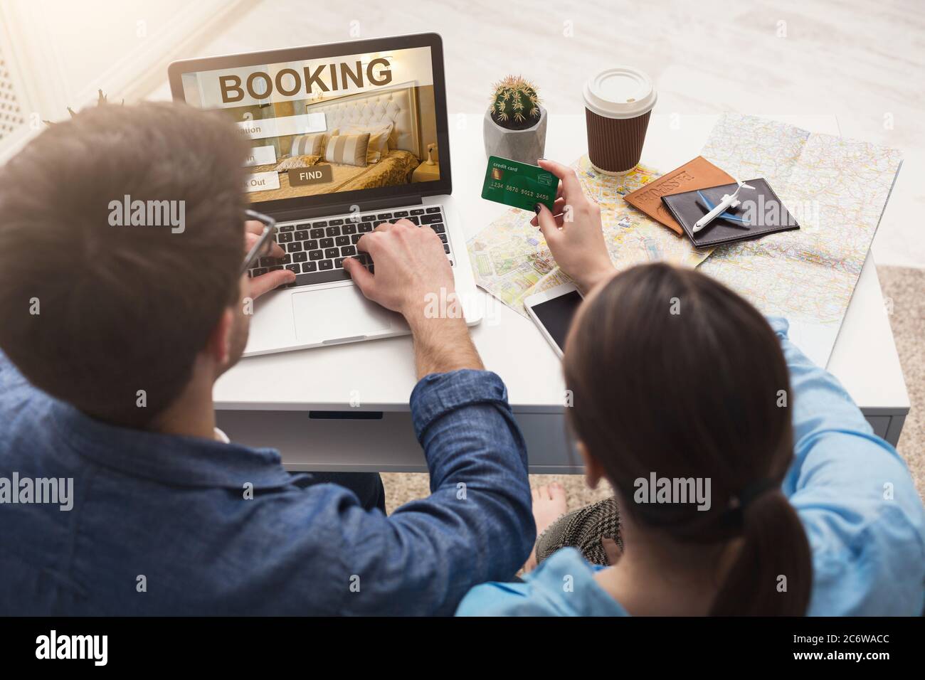 Couple planning trip, searching hotel and paying online Stock Photo - Alamy