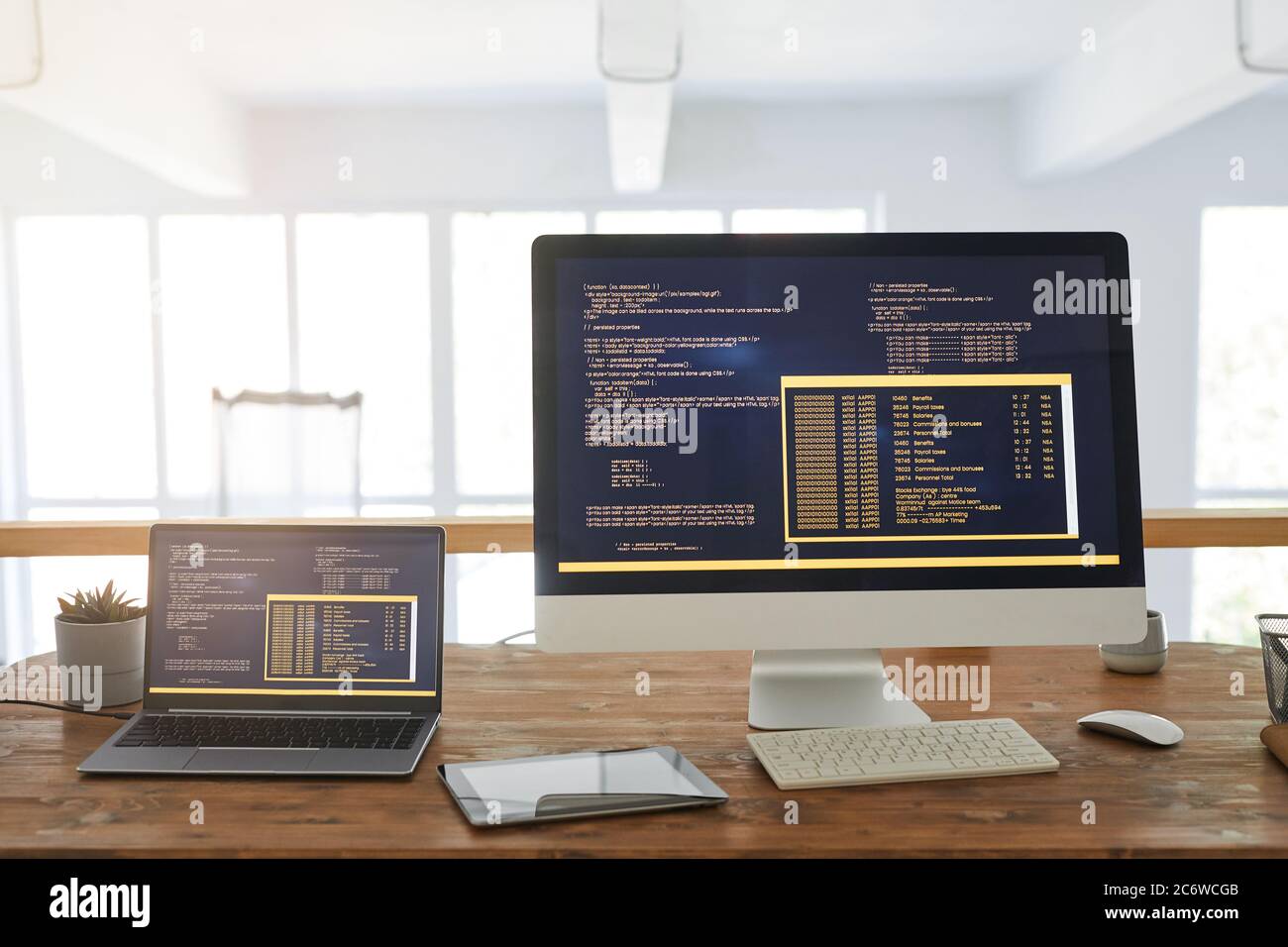 Front view background image of two computers with programming code on ...