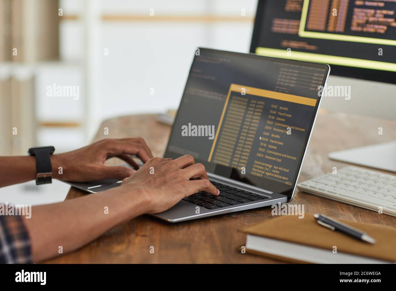 Close Up Of African American Computer Programmer Typing On Keyboard With Black And Orange