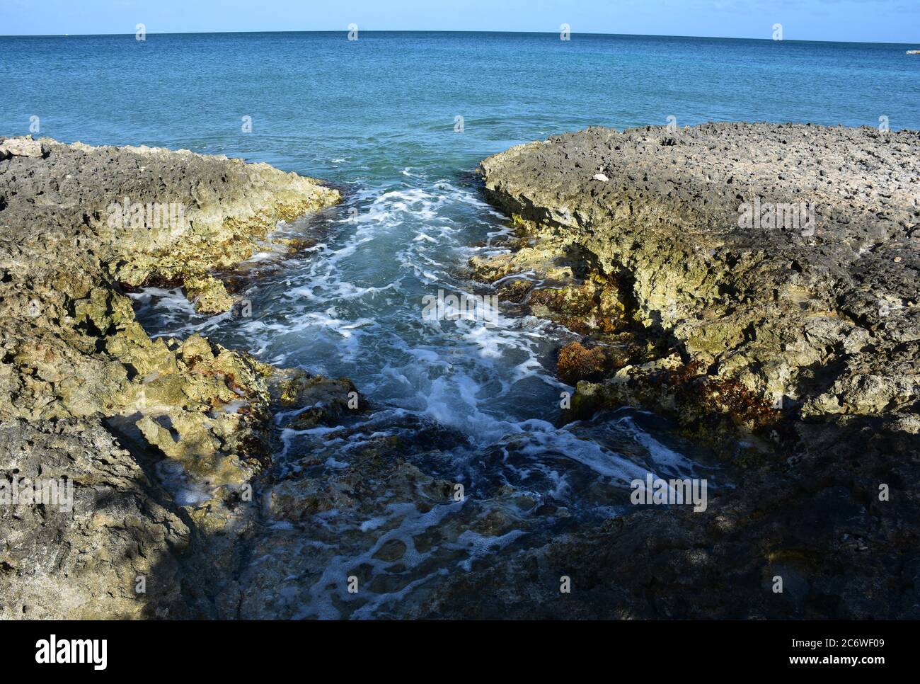 Aruba's coast with rugged lava rock and tropical blue waters Stock ...