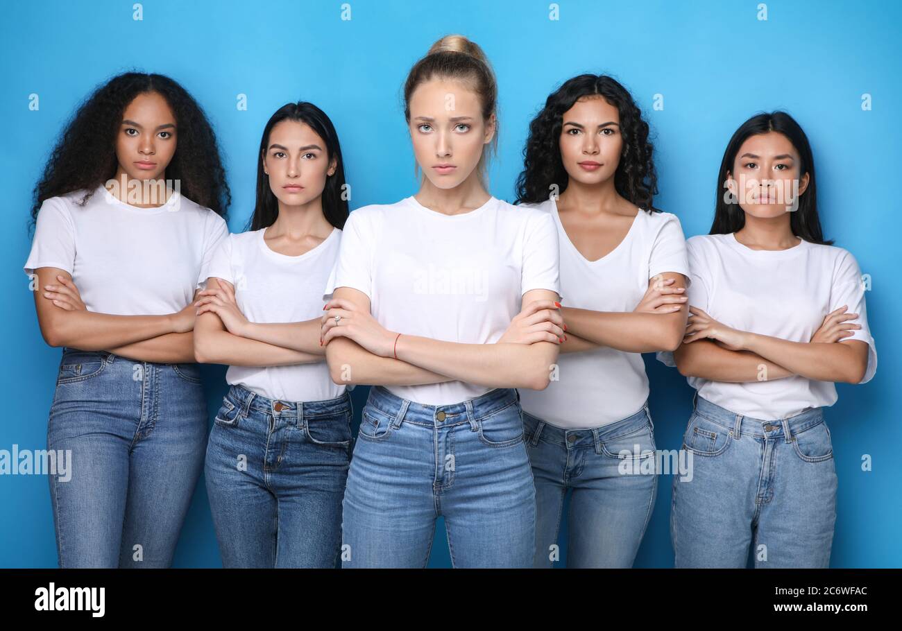 Discontented Girls Posing Crossing Hands Looking At Camera In Studio ...