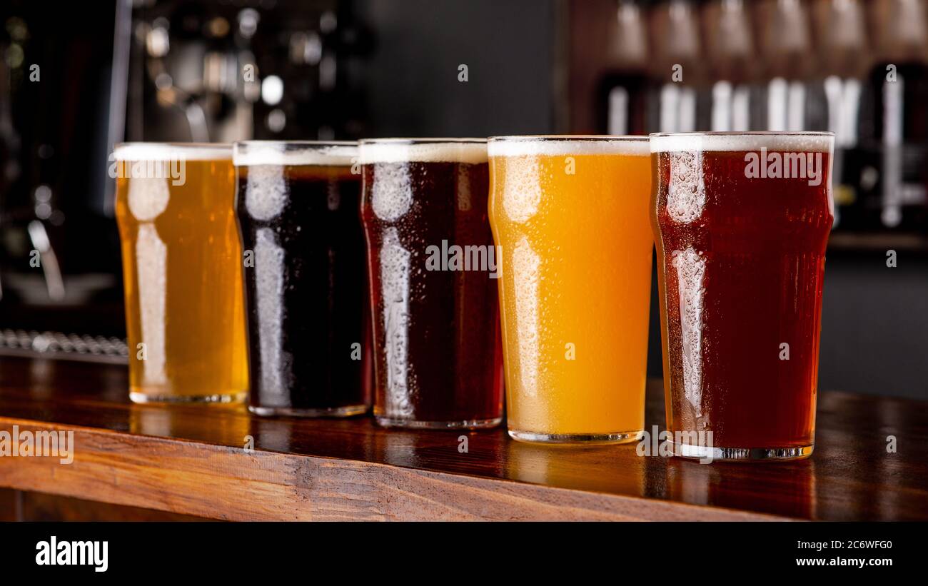 Unfiltered, dark, light beer, lager and ale in big glass glasses on ...
