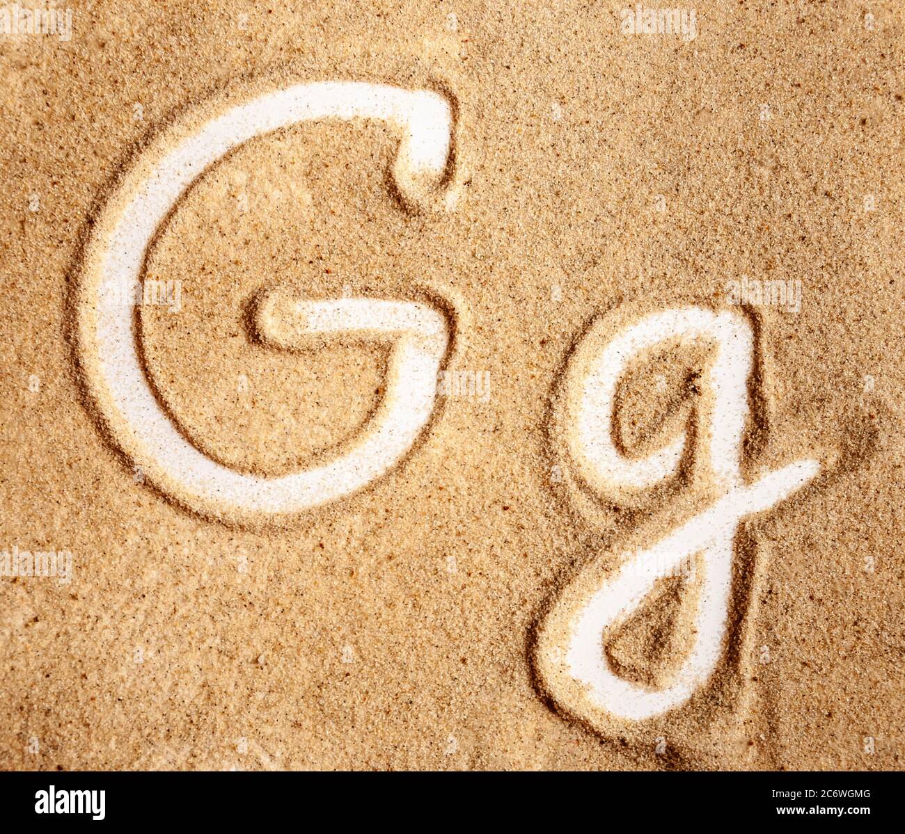 Letter G. English Handwritten Alphabet In The Sand Stock Photo - Alamy
