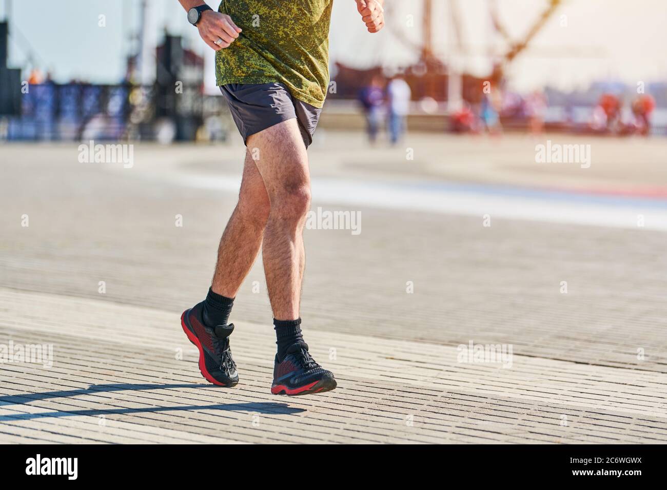 Running man. Athletic man jogging in sportswear on city road. Healthy lifestyle, fitness sport ...