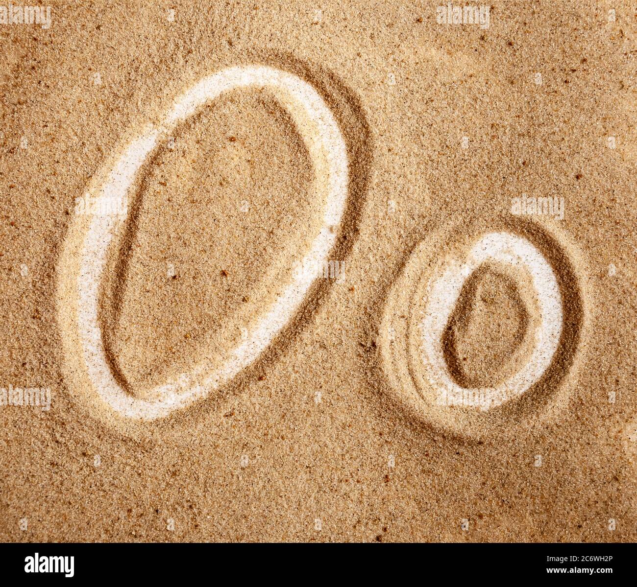 Letter O. English Handwritten Alphabet In The Sand Stock Photo - Alamy