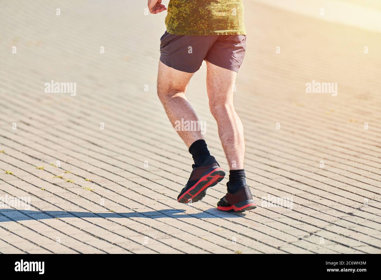 Running man. Athletic man jogging in sportswear on city road. Healthy lifestyle, fitness sport ...