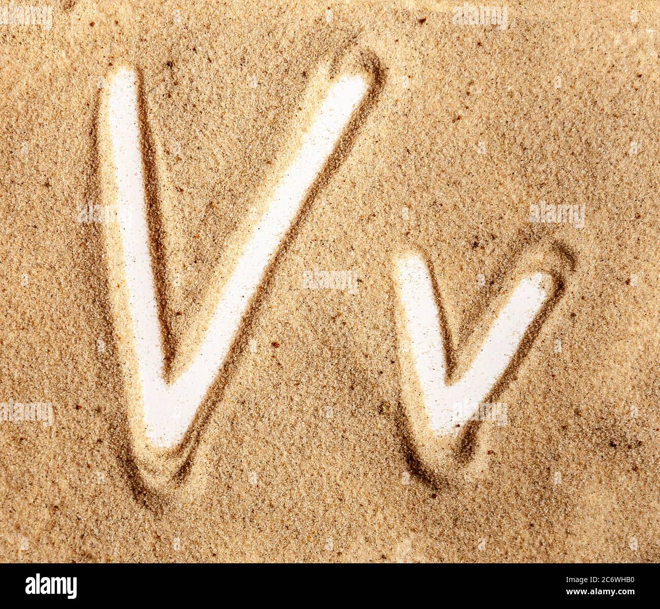 Letter V. English Handwritten Alphabet In The Sand Stock Photo - Alamy