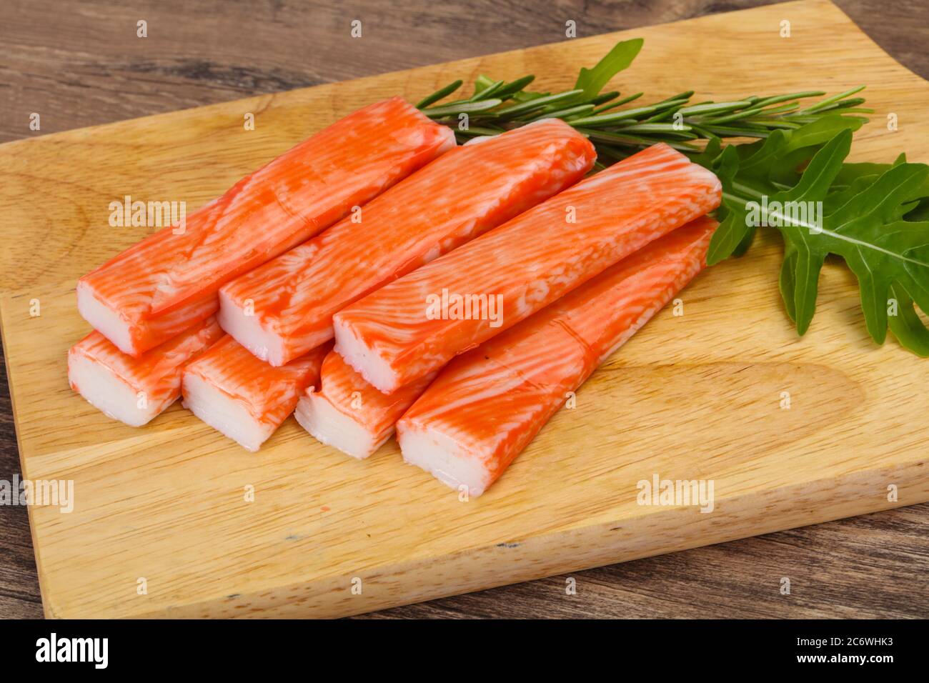 Crab stick surimi over wooden board Stock Photo - Alamy
