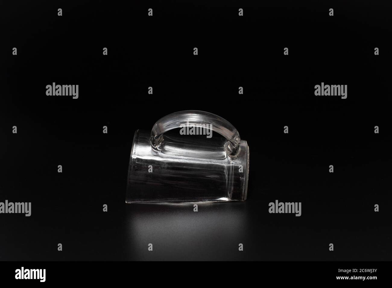 Half broken glass cup on black background Stock Photo - Alamy