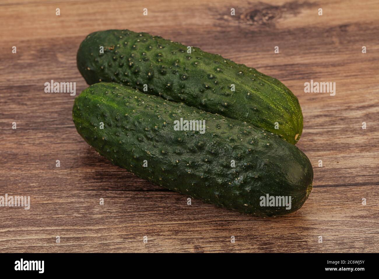 Green fresh two cucumbers over background Stock Photo - Alamy