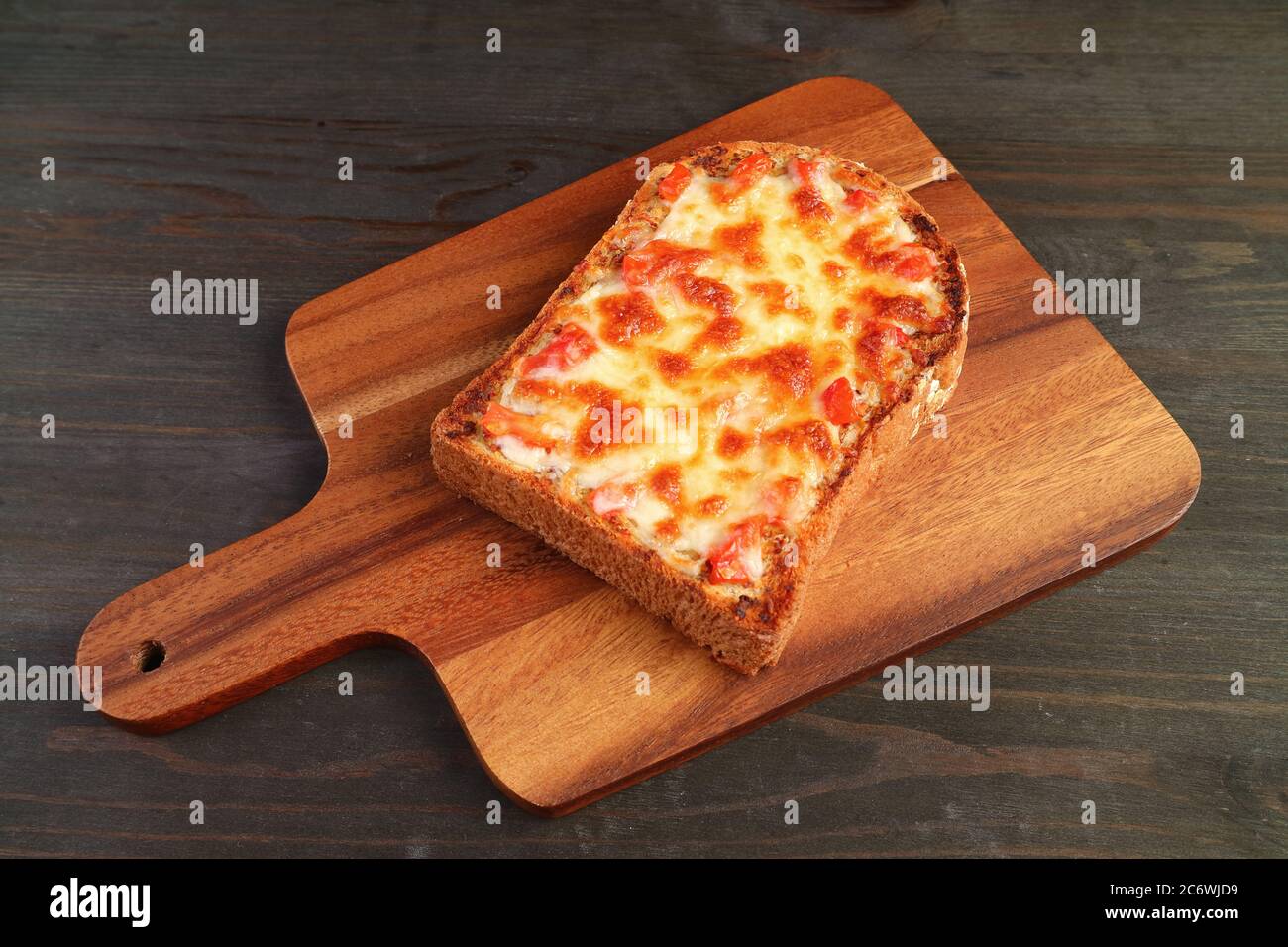 Delectable homemade tomato and cheese pizza toast isolated on wooden ...