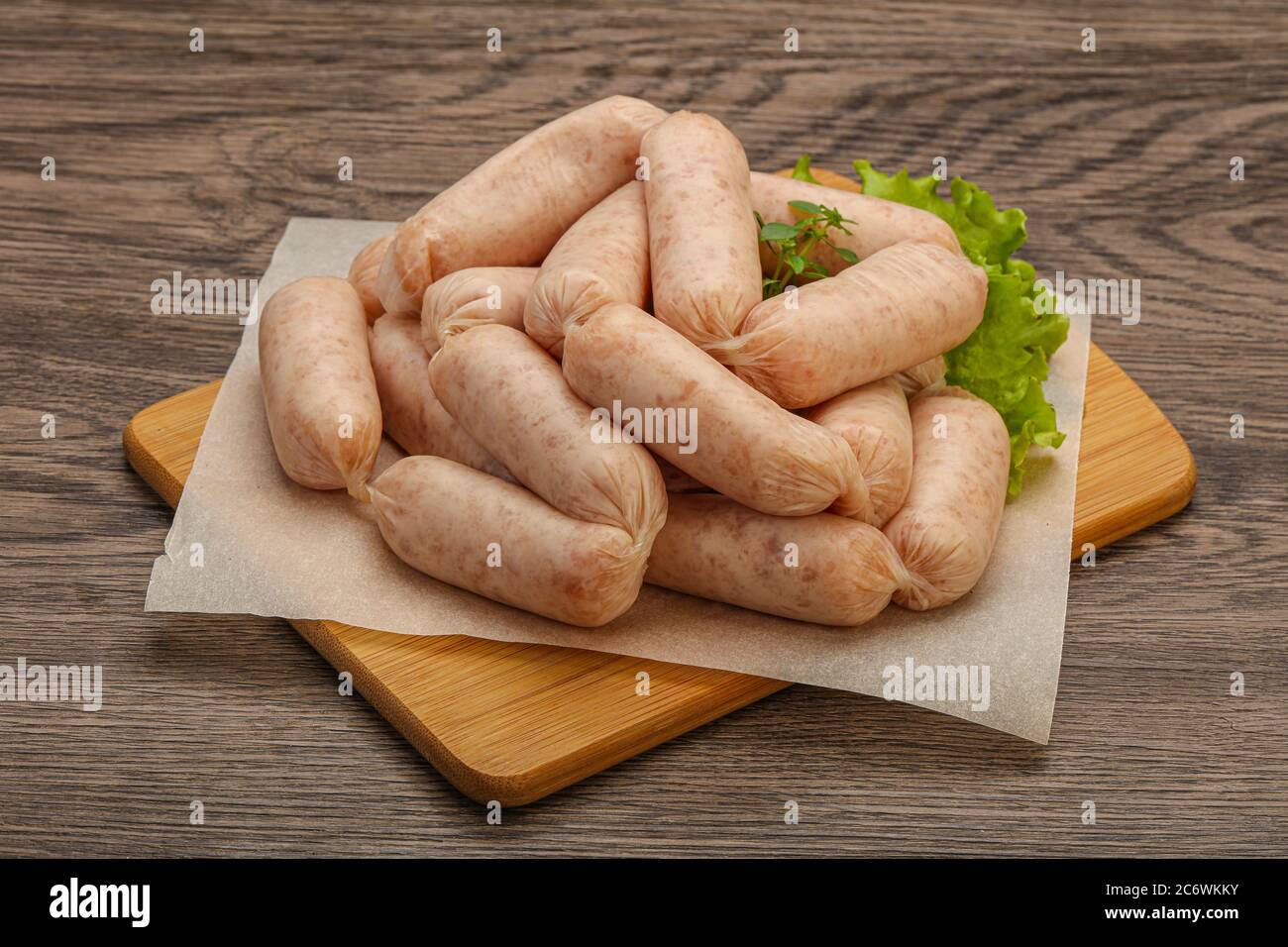 Raw natural chicken baby sausages for roast Stock Photo - Alamy