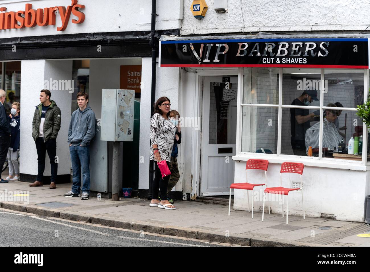 A long queue formed outside a barber’s shop for an overdue haircut in ...