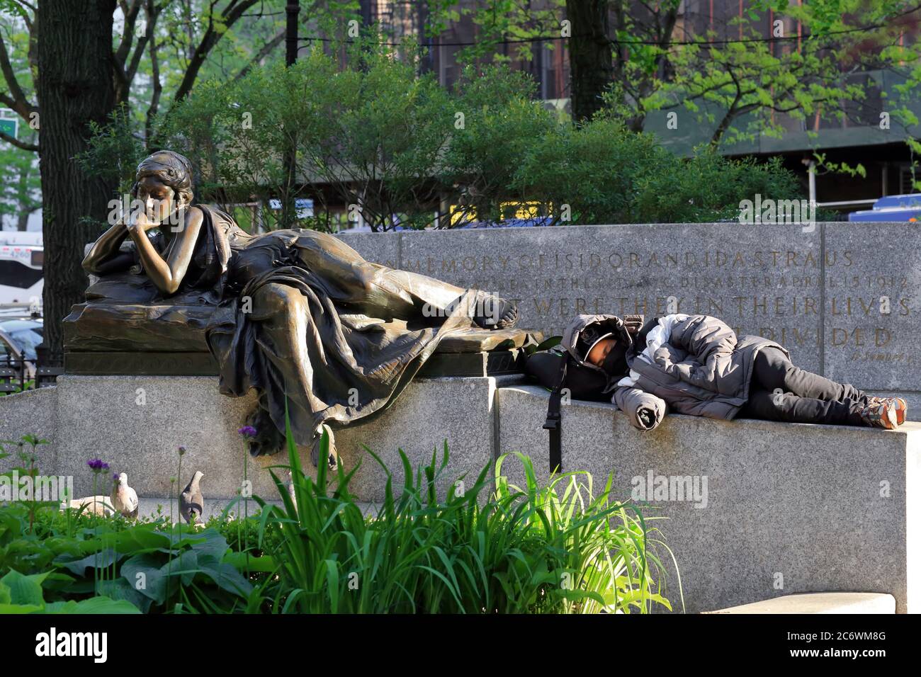 A person naps at the foot of the bronze statue "Memory" by sculptor ...