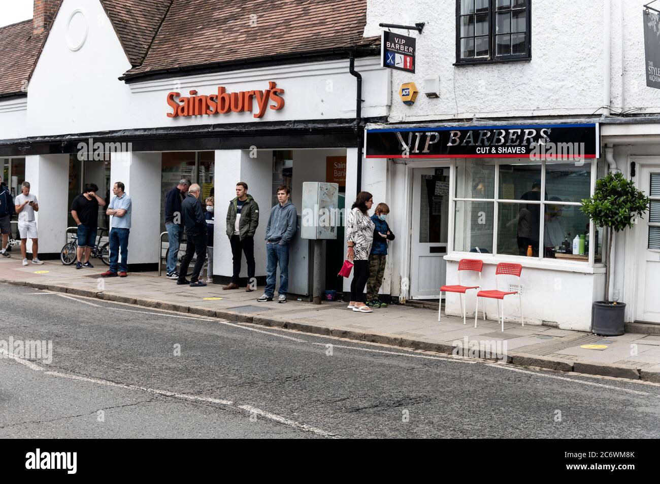 A long queue formed outside a barber’s shop for an overdue haircut in ...