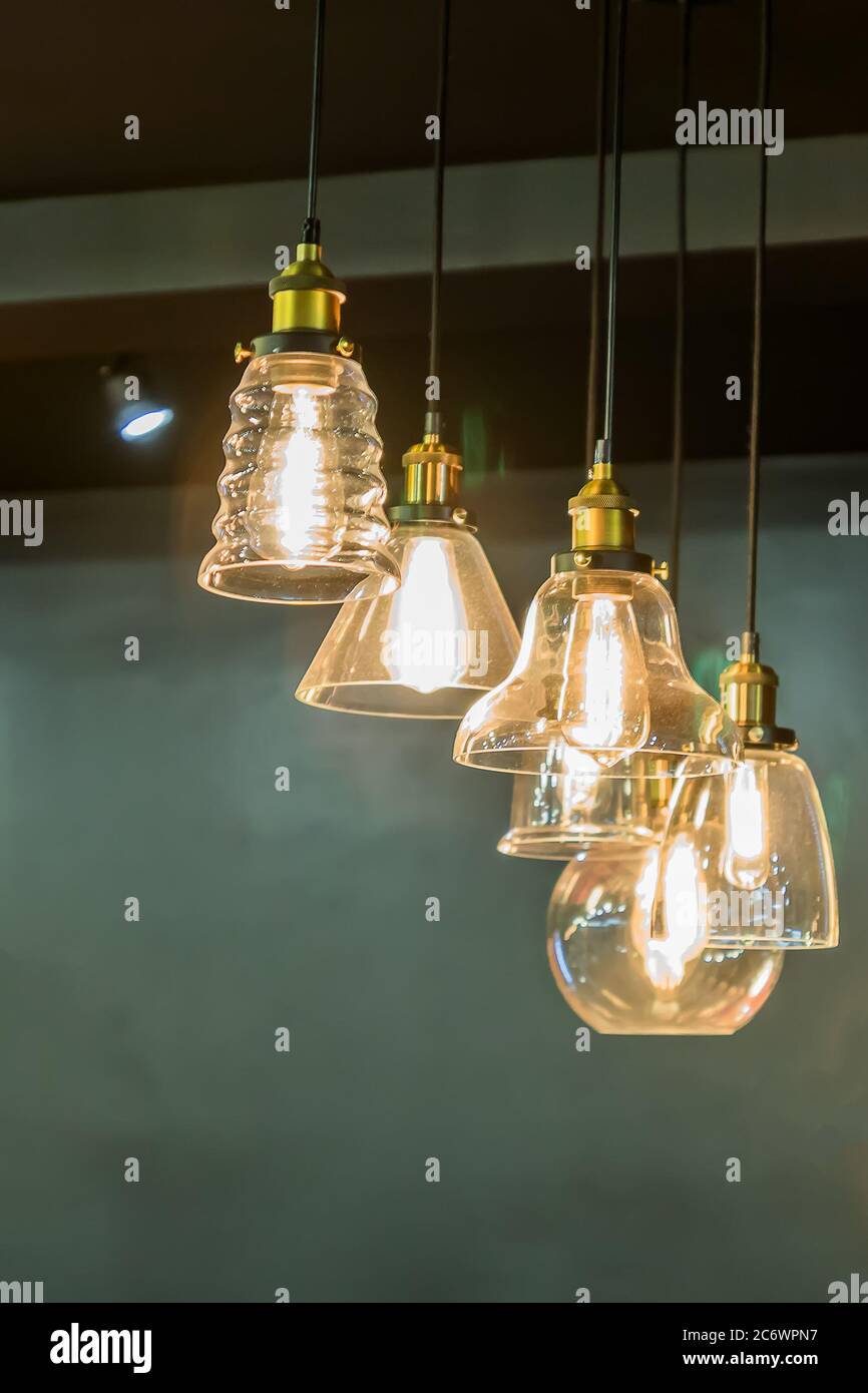 loft interior details. hanging lamps with lights on Stock Photo - Alamy