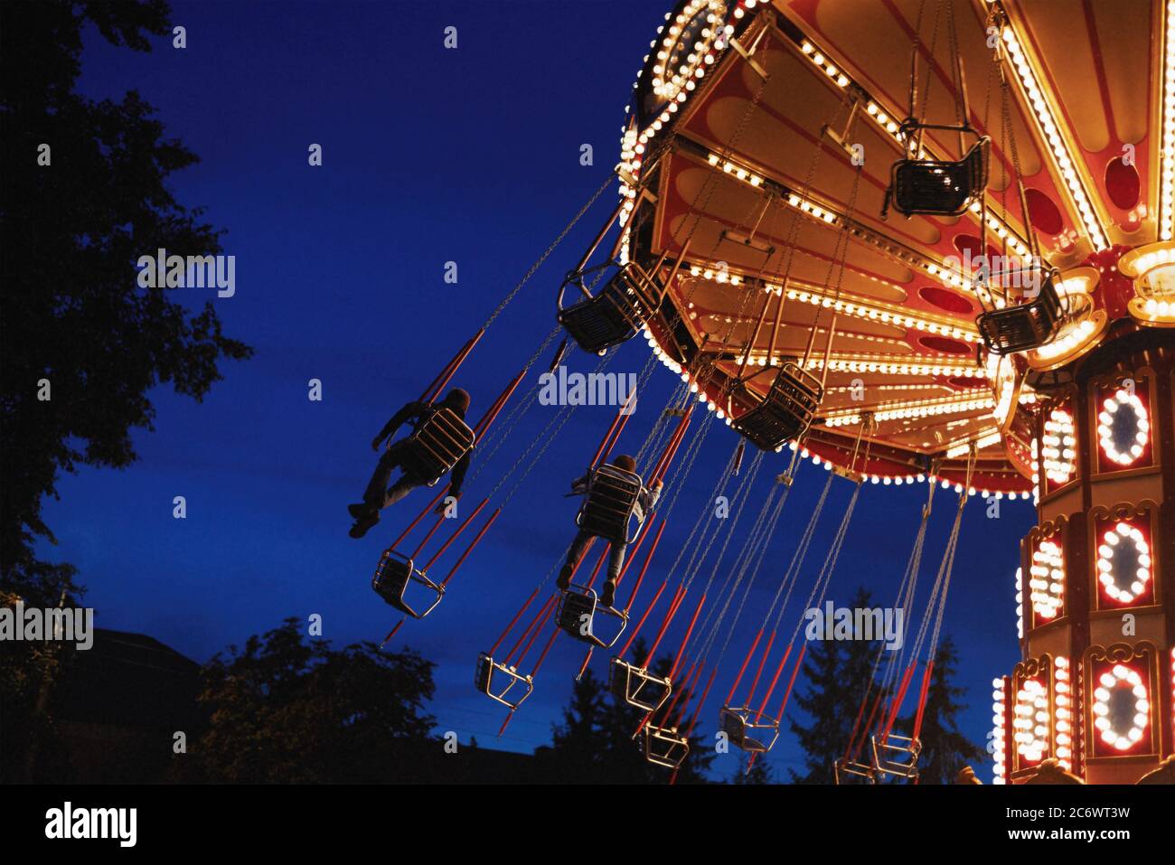 Carousel Merry-go-round in amusement park at night city Stock Photo - Alamy