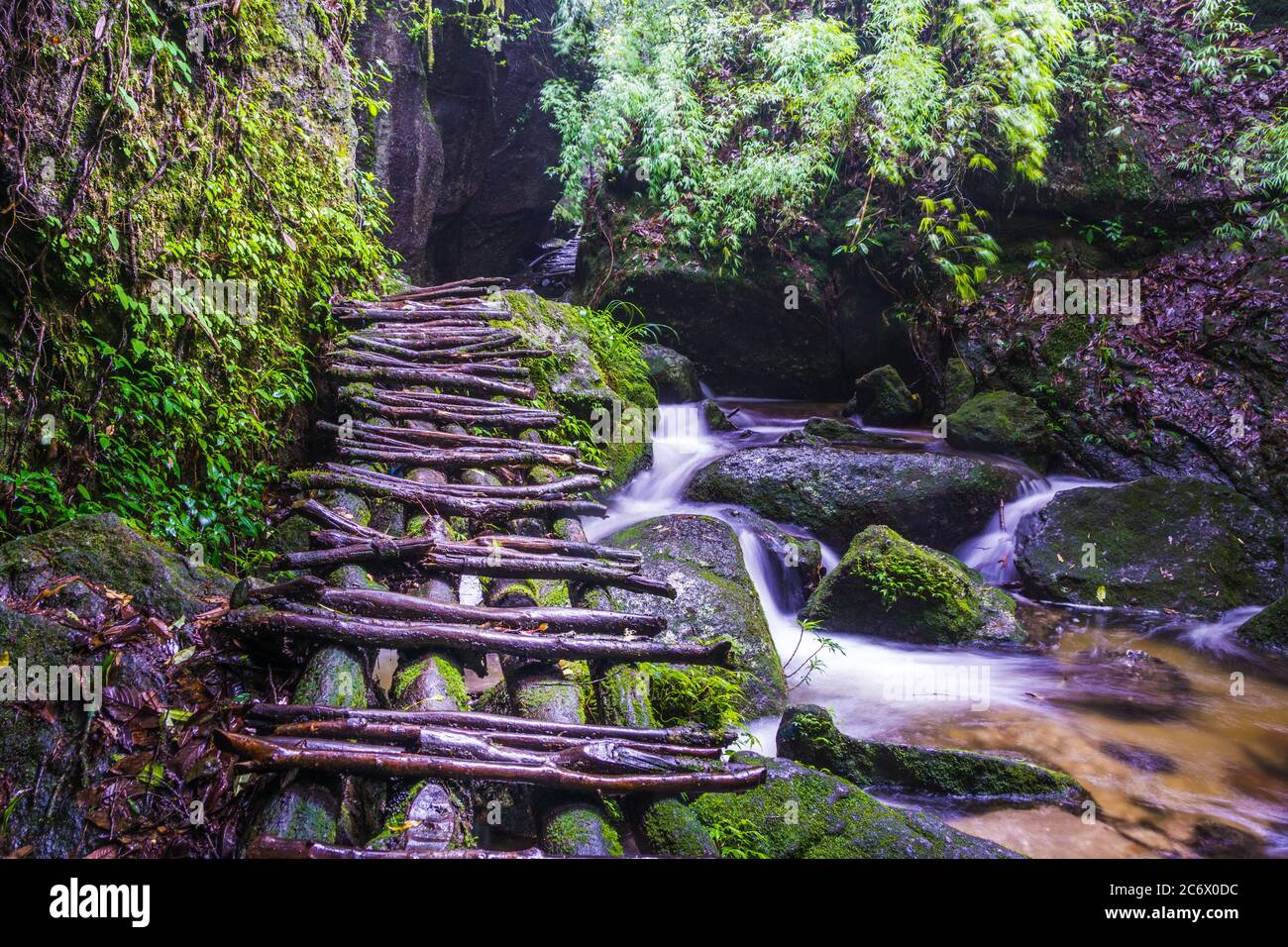 Beautiful cascade and wooden cross bridge Stock Photo - Alamy