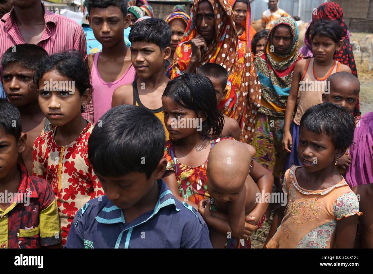 Flood affected people gather for aid at a shelter center during the ...