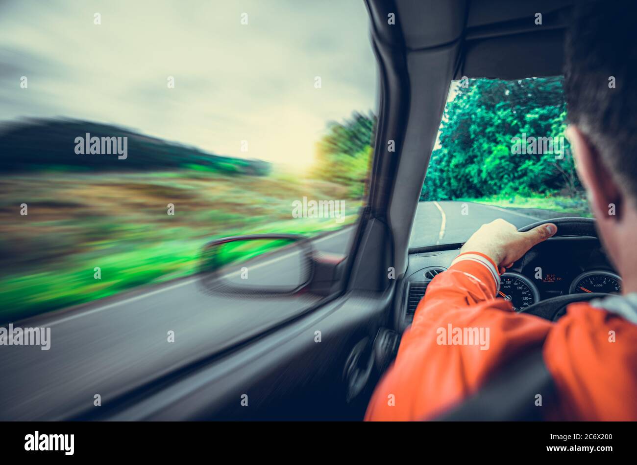 Man drives a car on a suburban highway Stock Photo - Alamy