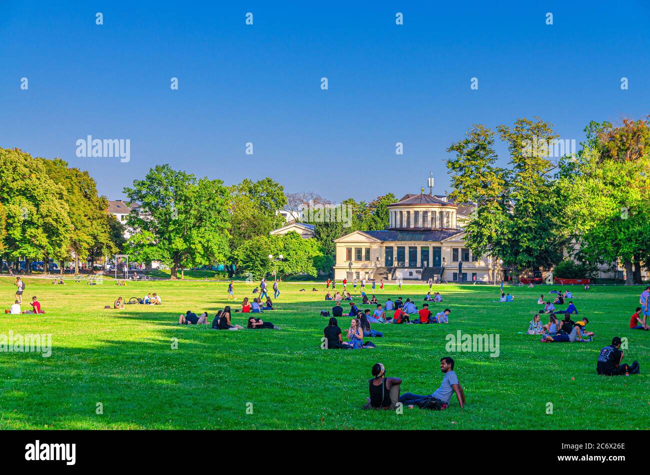 Bonn, Germany, August 23, 2019: young people having rest on grass lawn ...