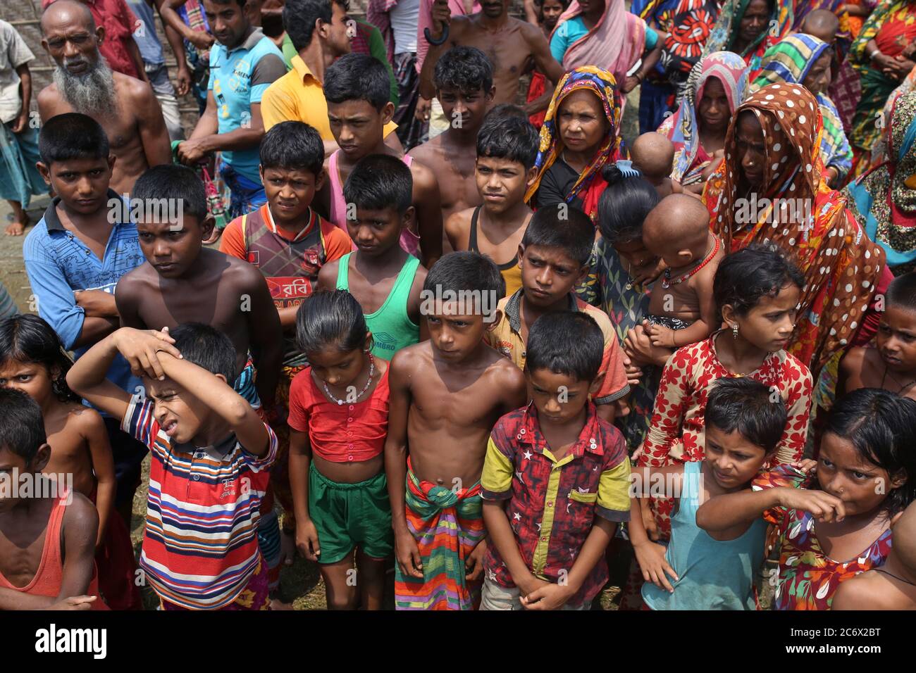 Flood affected people gather for aid at a shelter center during the ...