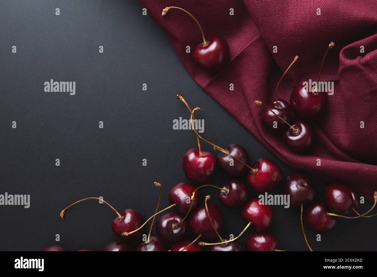 Cherry background. Cherries on a black top view. Elegant rich cherry ...