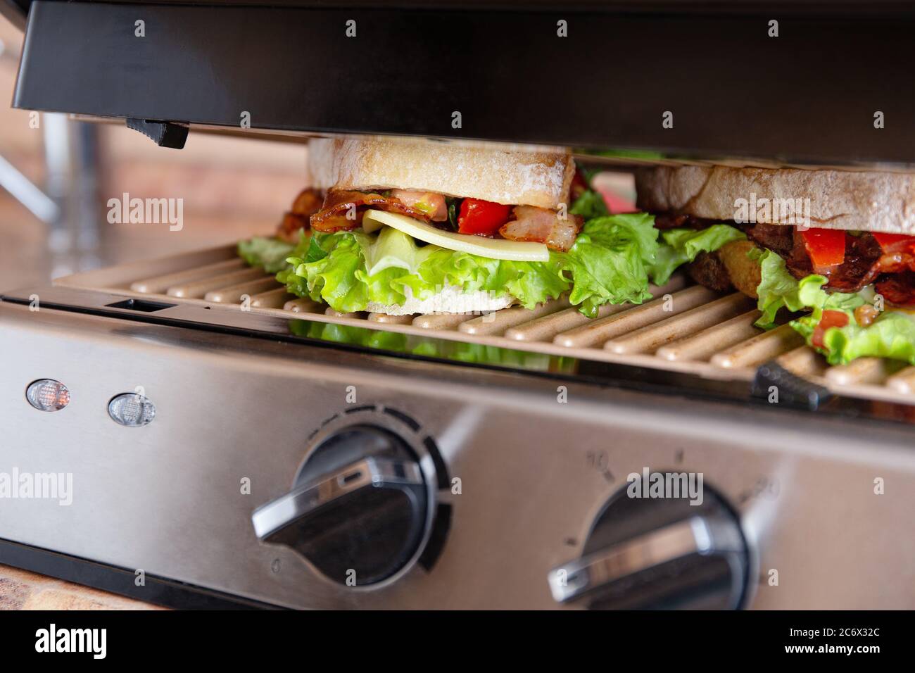 Grilled long sandwich or panini on the grill of an electric grill ...