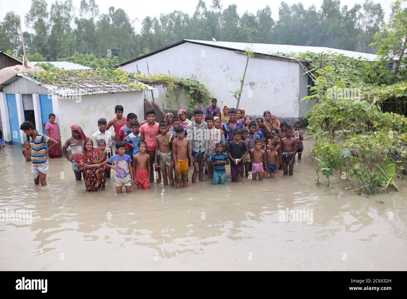 Flood affected people gather for aid during the monsoon flood in ...
