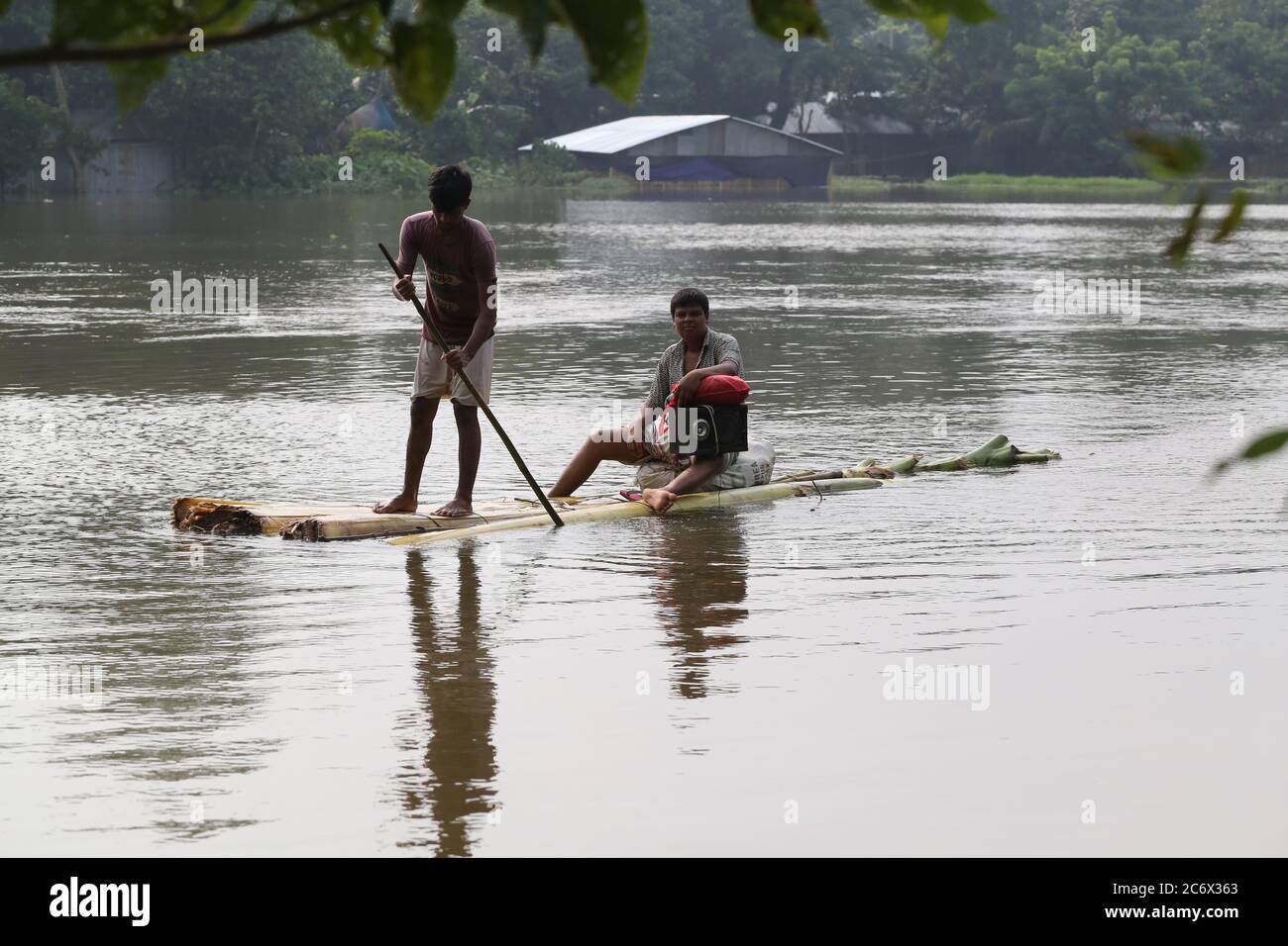 People move on raft made of banana tree trunks during the flood in ...
