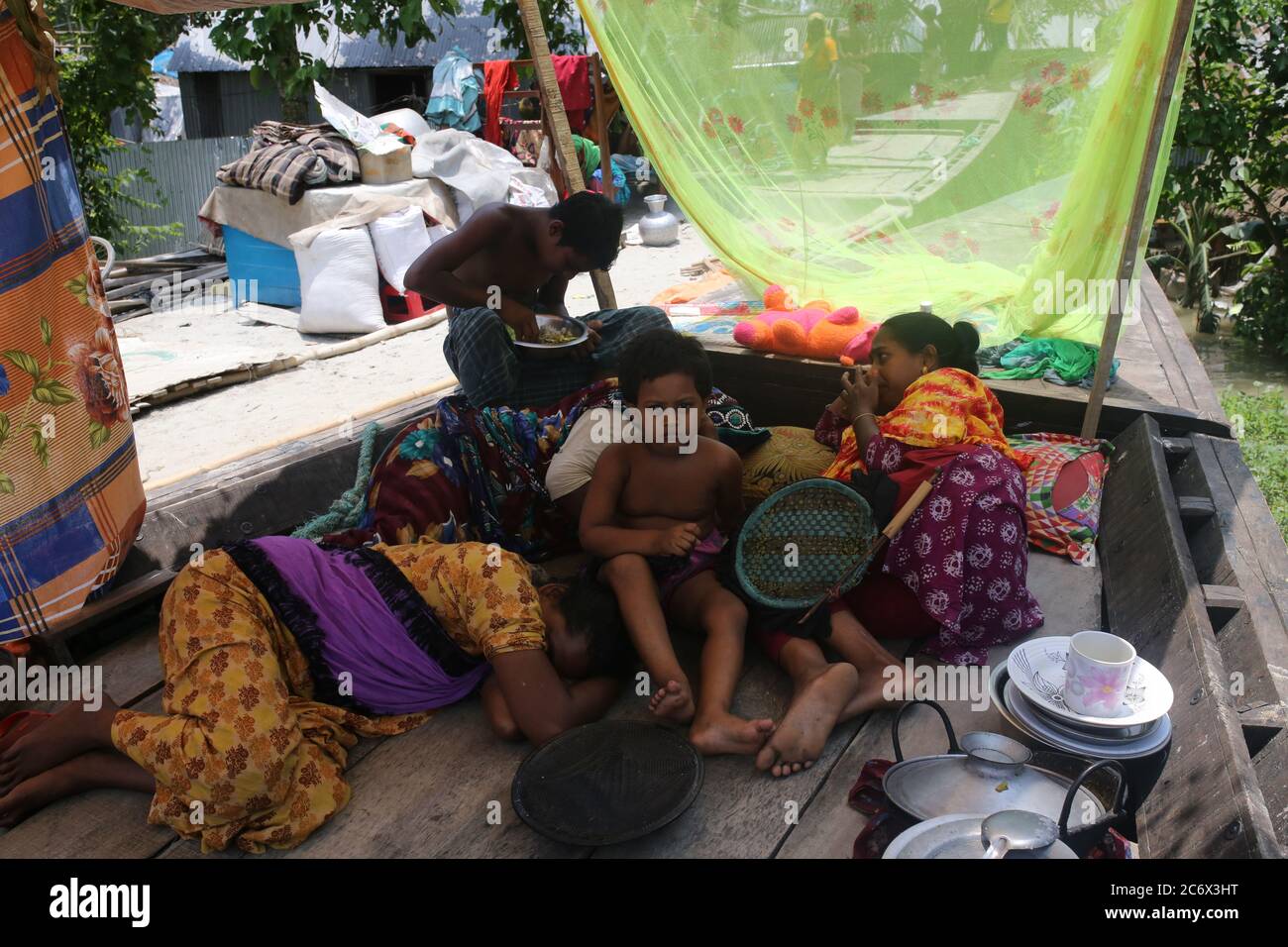 Flood affected people take shelter on a boat during the monsoon flood ...