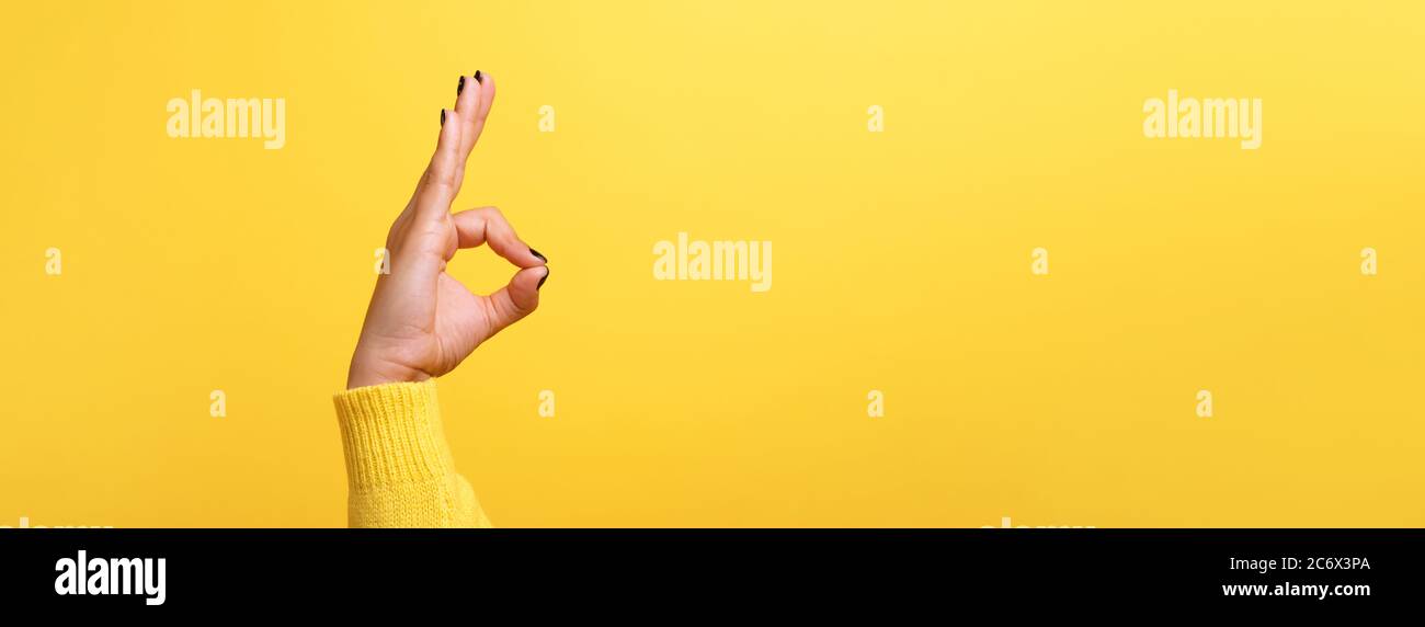 hand ok sign over trend yellow background Stock Photo - Alamy