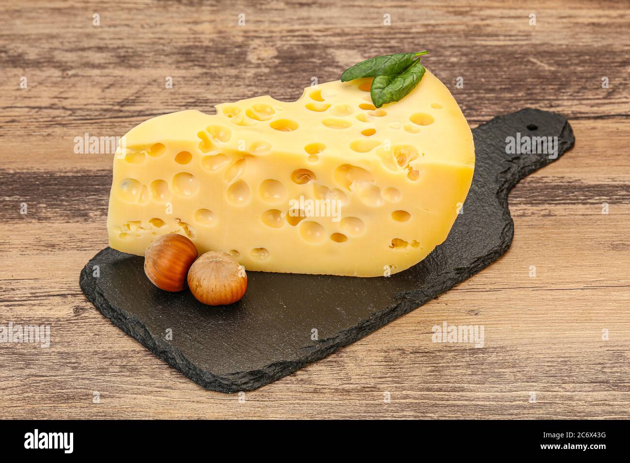 Maasdam cheese - dairy yellow triangle with holes Stock Photo - Alamy