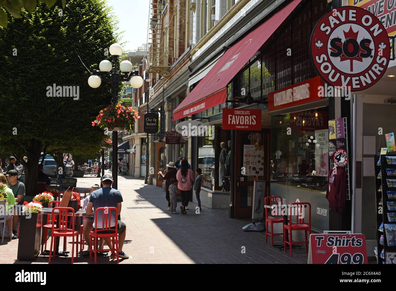 Pedestrians and restaurant patrons enjoy the shops along Government ...