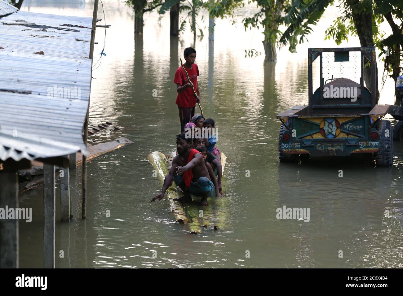 People move on raft made of banana tree trunks during the flood in ...