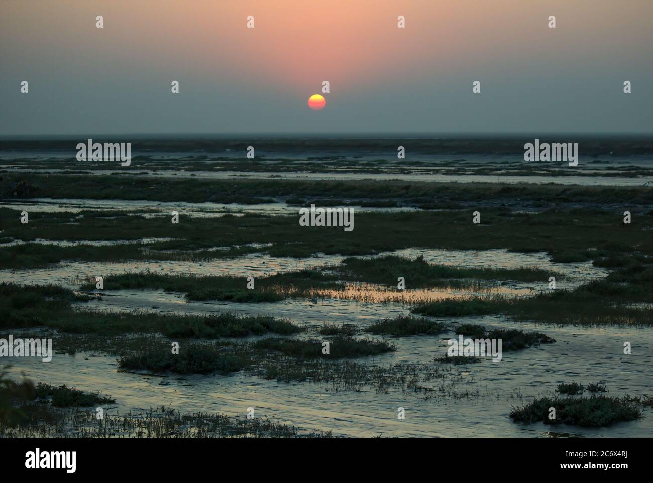 Sunset on a dried beach in Khambhat located in Gujarat state of India ...