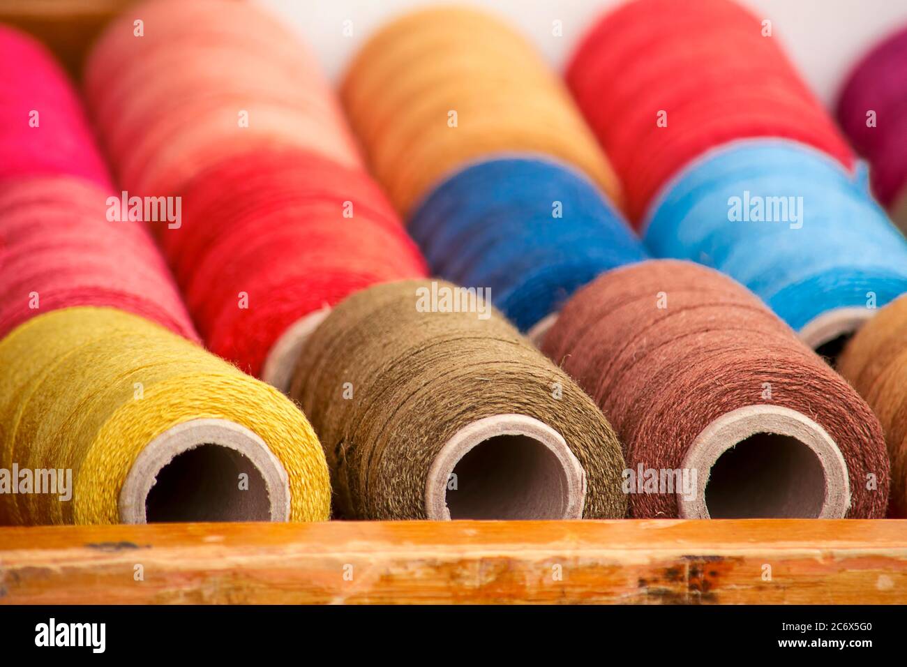 Sewing threads of different colors stacked in a drawer Stock Photo - Alamy