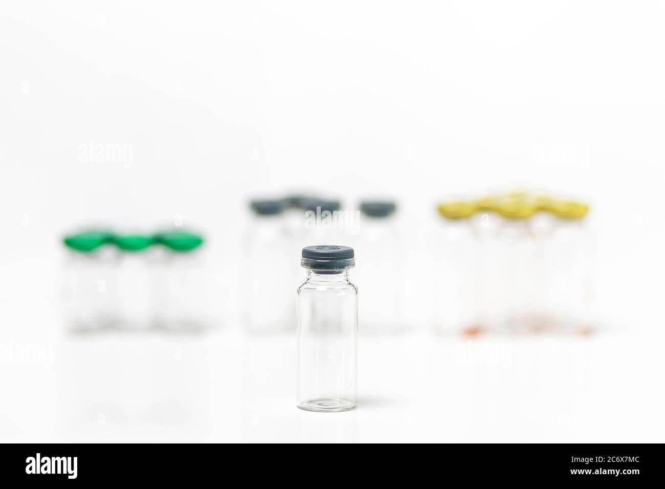 Close-up of clean and empty medical vials with caps isolated on white ...