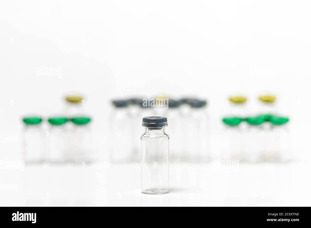 Close-up of clean and empty medical vials with caps isolated on white ...