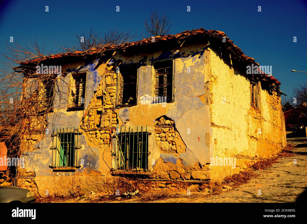 damaged old house, painted blue, street Stock Photo - Alamy