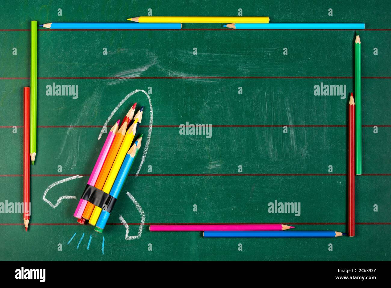 Rocket ship made of pencils on the green chalkboard with pencils frame ...