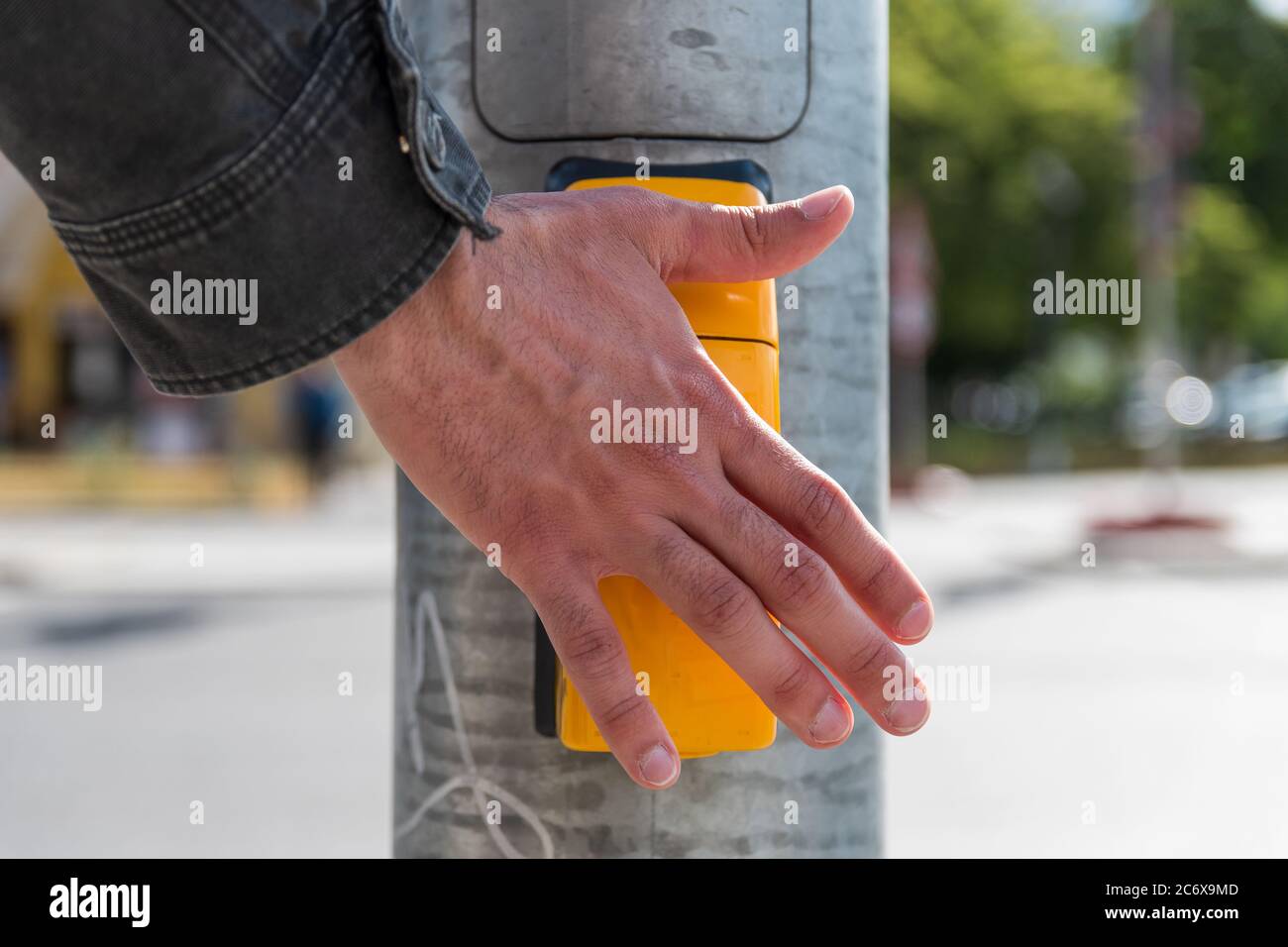 Close up of an adult male hand is pressing button or giving touchless ...