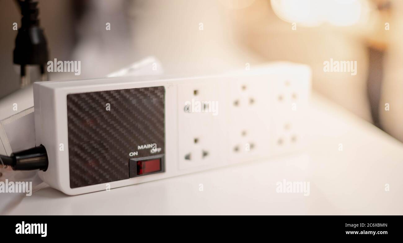 The electrical white external adapter plug with power button and six ...