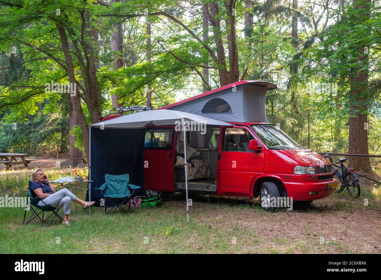 red VW T4v camper California at campsite in Gelderland, Holland Stock ...