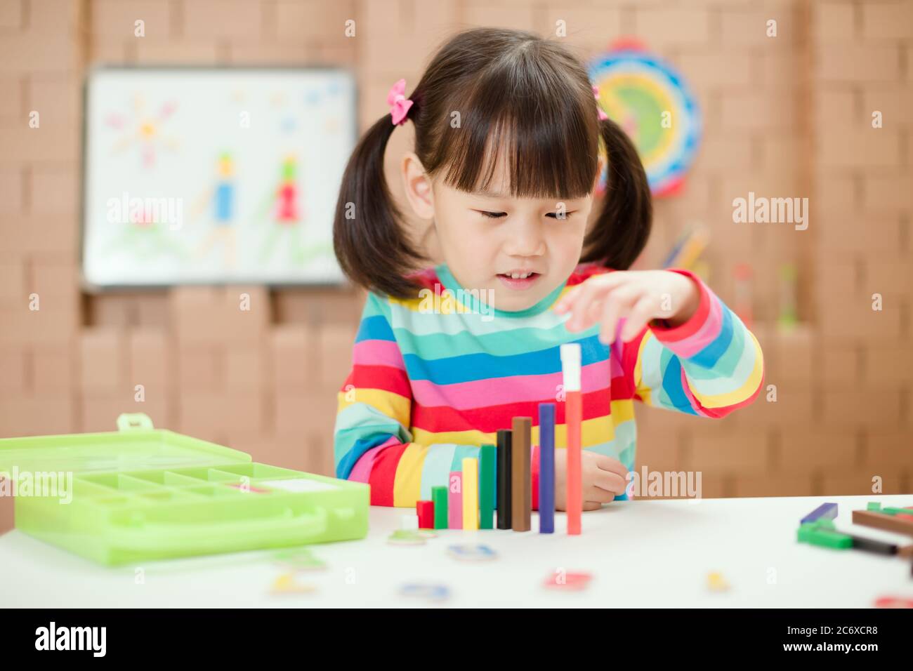 toddler girl play number sticks for homeschooling Stock Photo - Alamy