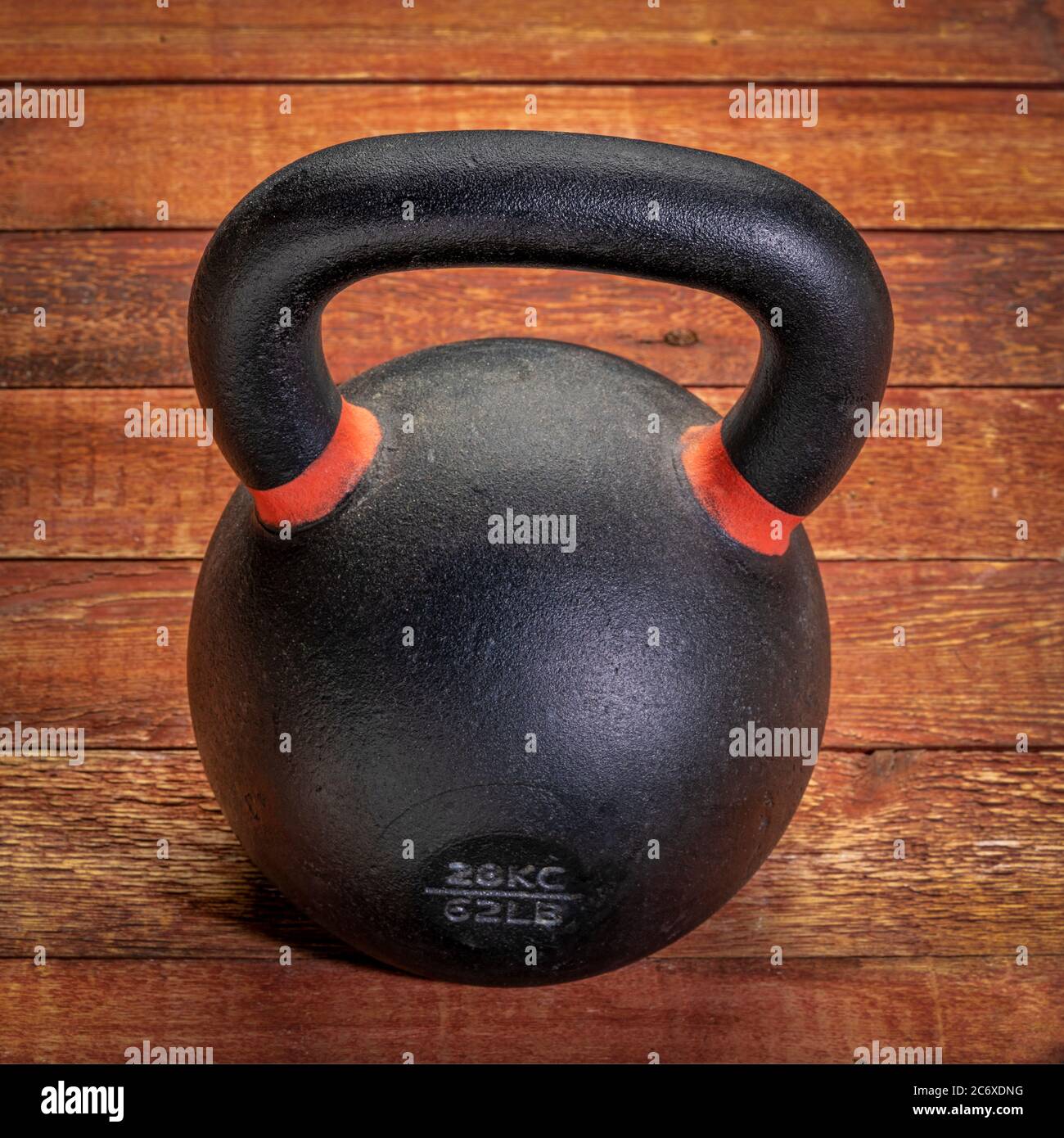 heavy iron kettlebell on a rustic wood background, fitness and gym ...